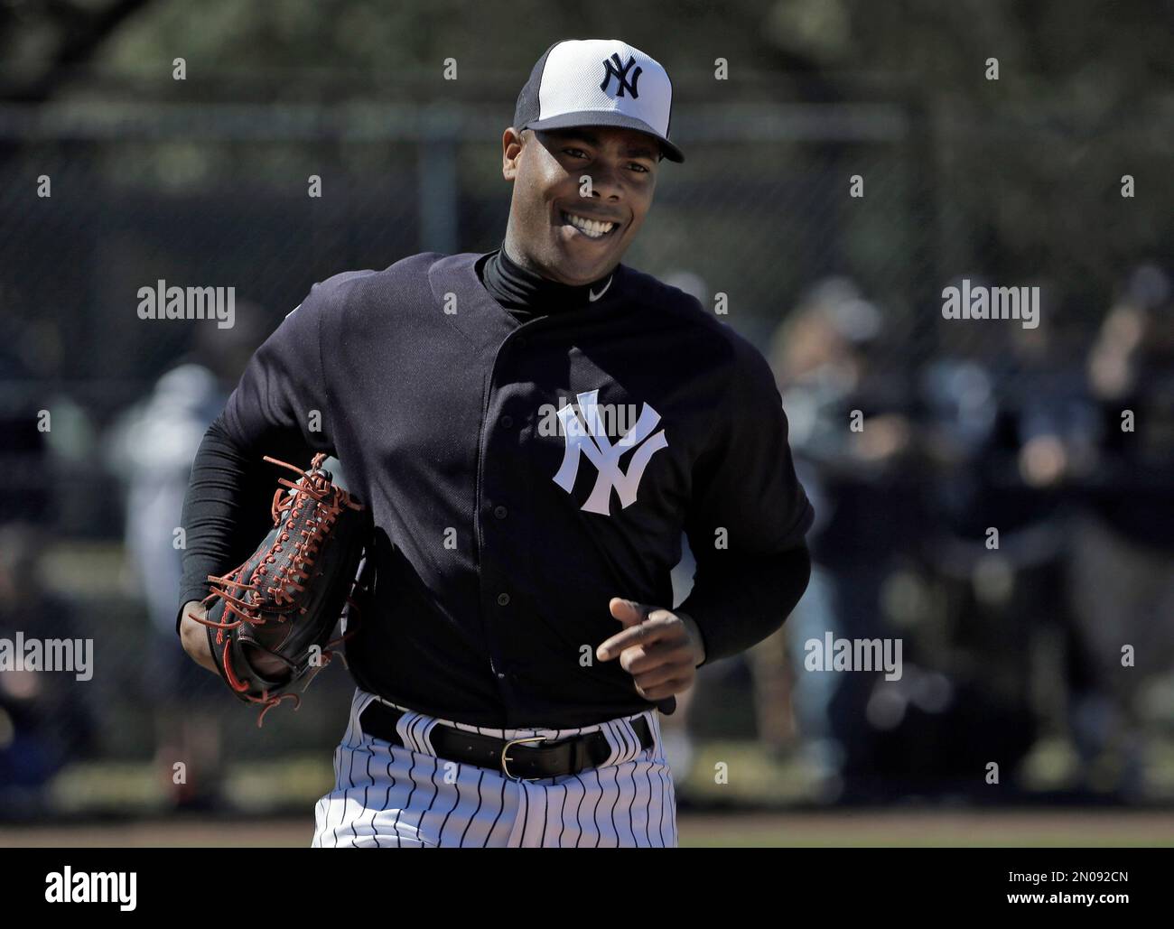 New York Yankees pitcher Aroldis Chapman smiles as he runs pickoff ...