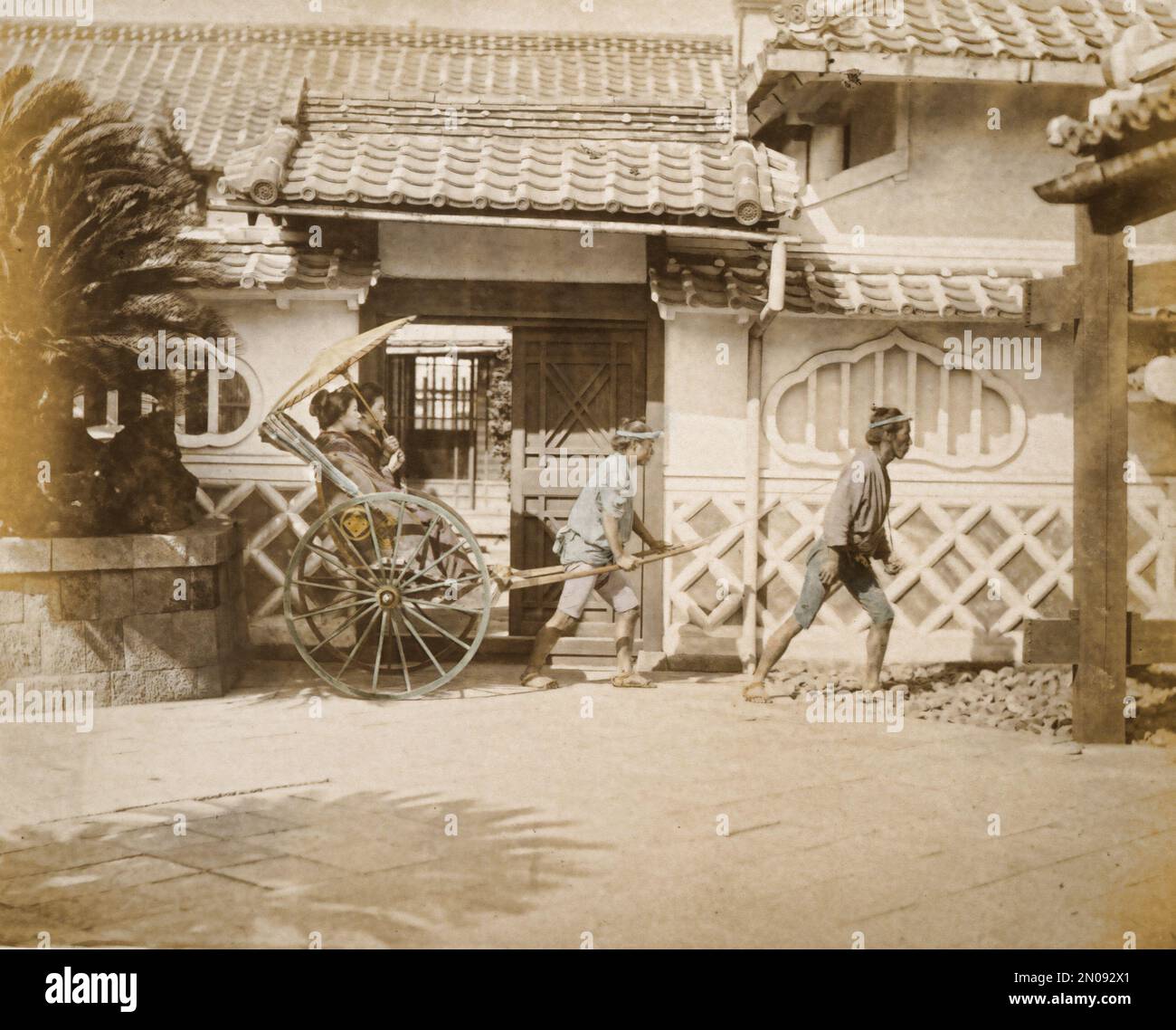 A photograph of two Japanese women in a pulled rickshaw. Published in ...