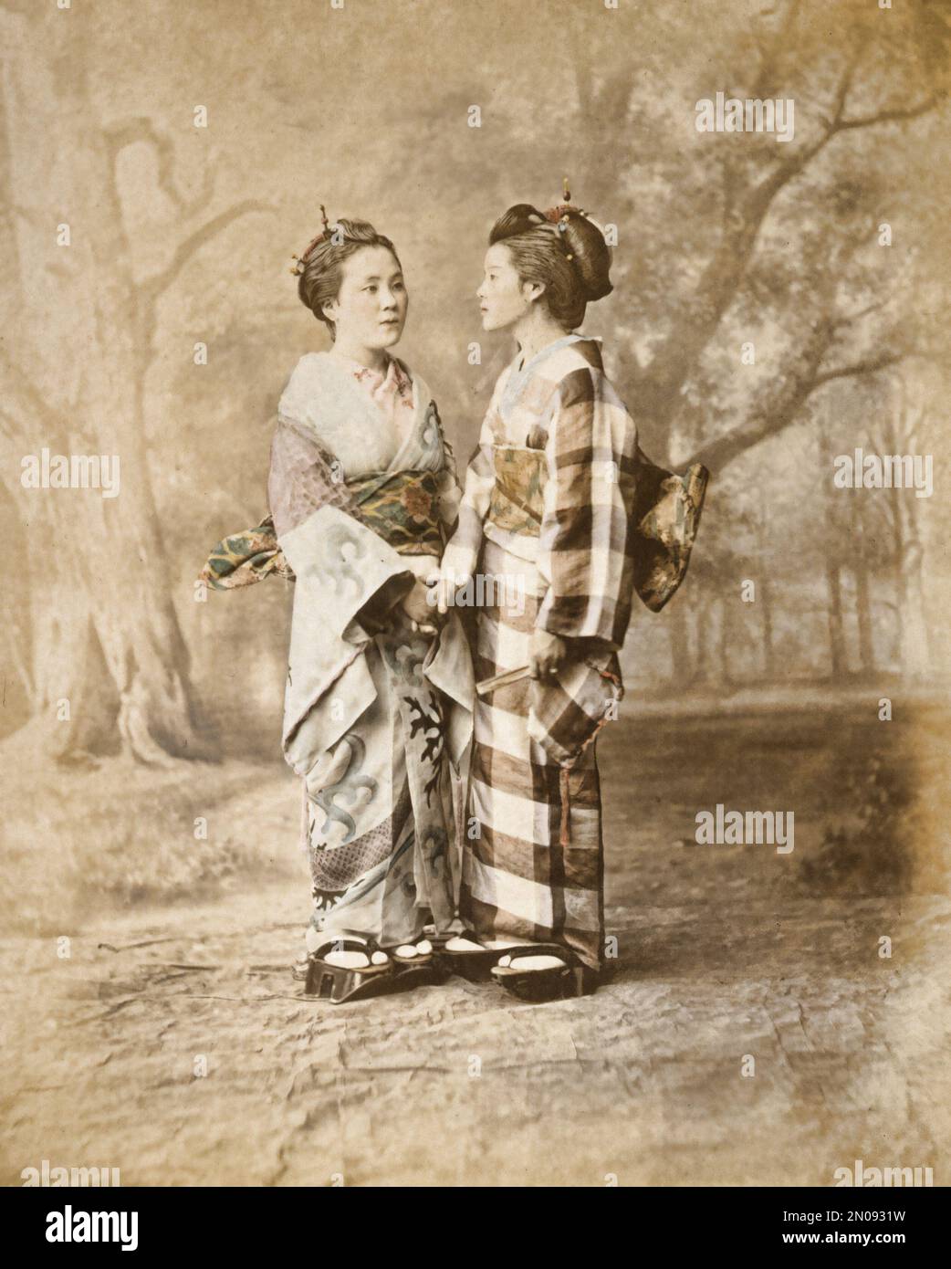 A photograph of two Japanese women in traditional costumes. Published ...