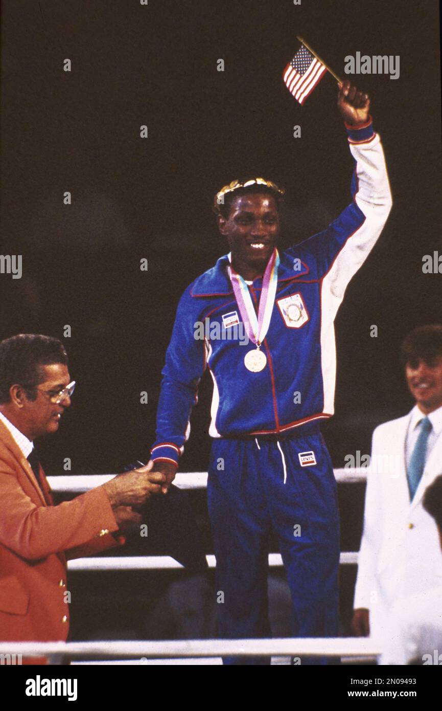 American boxer Pernell Whitaker holds an American flag after receiving ...