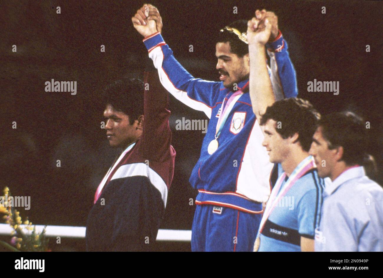 American boxer Jerry Page, center, holds aloft his arms after receiving ...