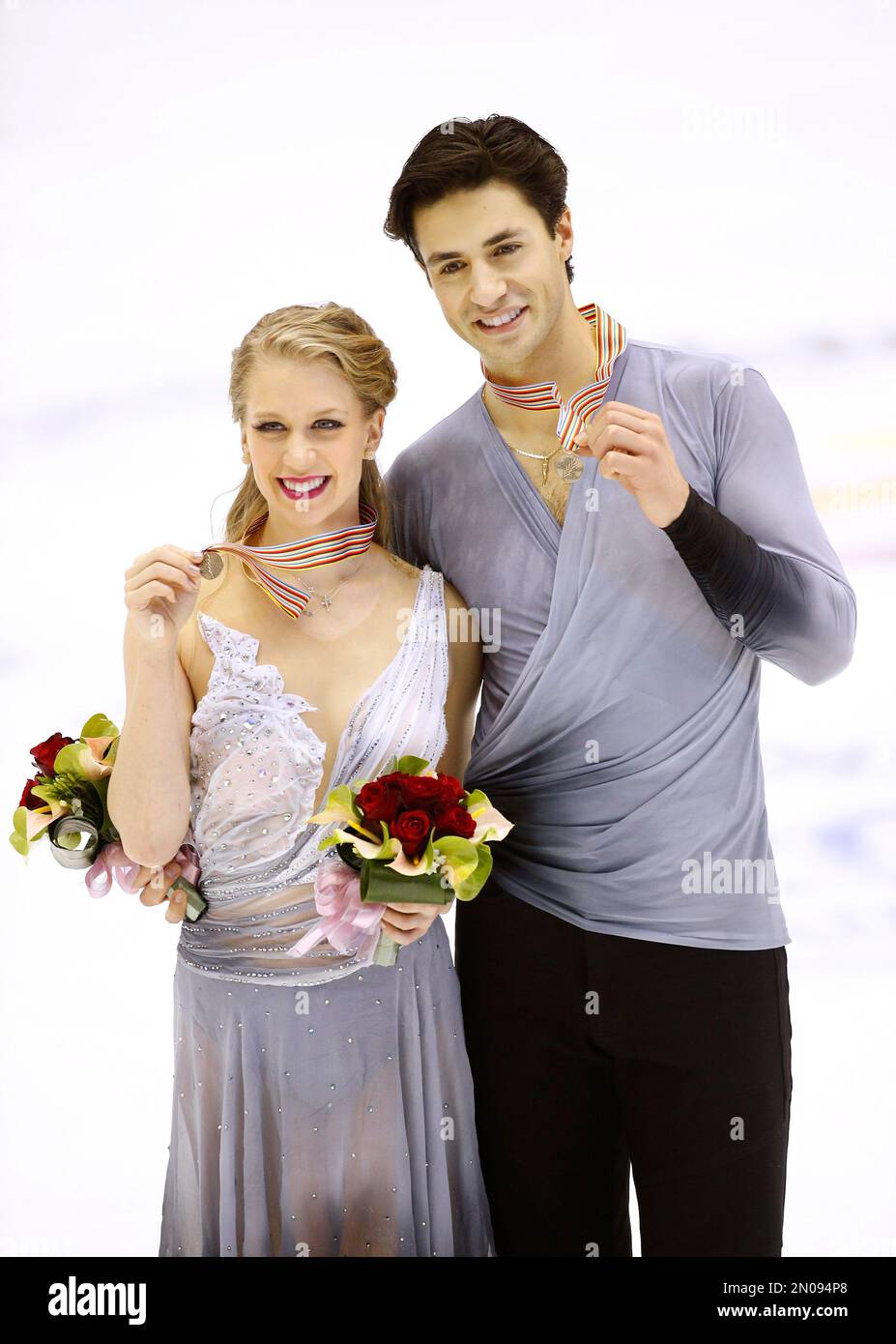 Third place winners Kaitlyn Weaver and Andrew Poje from Canada display their bronze medals after ...