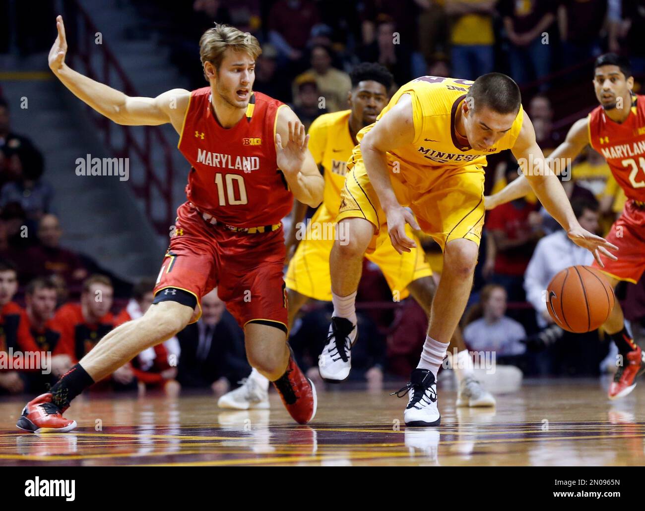 Minnesota's Joey King, right, reaches for the ball ahead of Maryland's ...