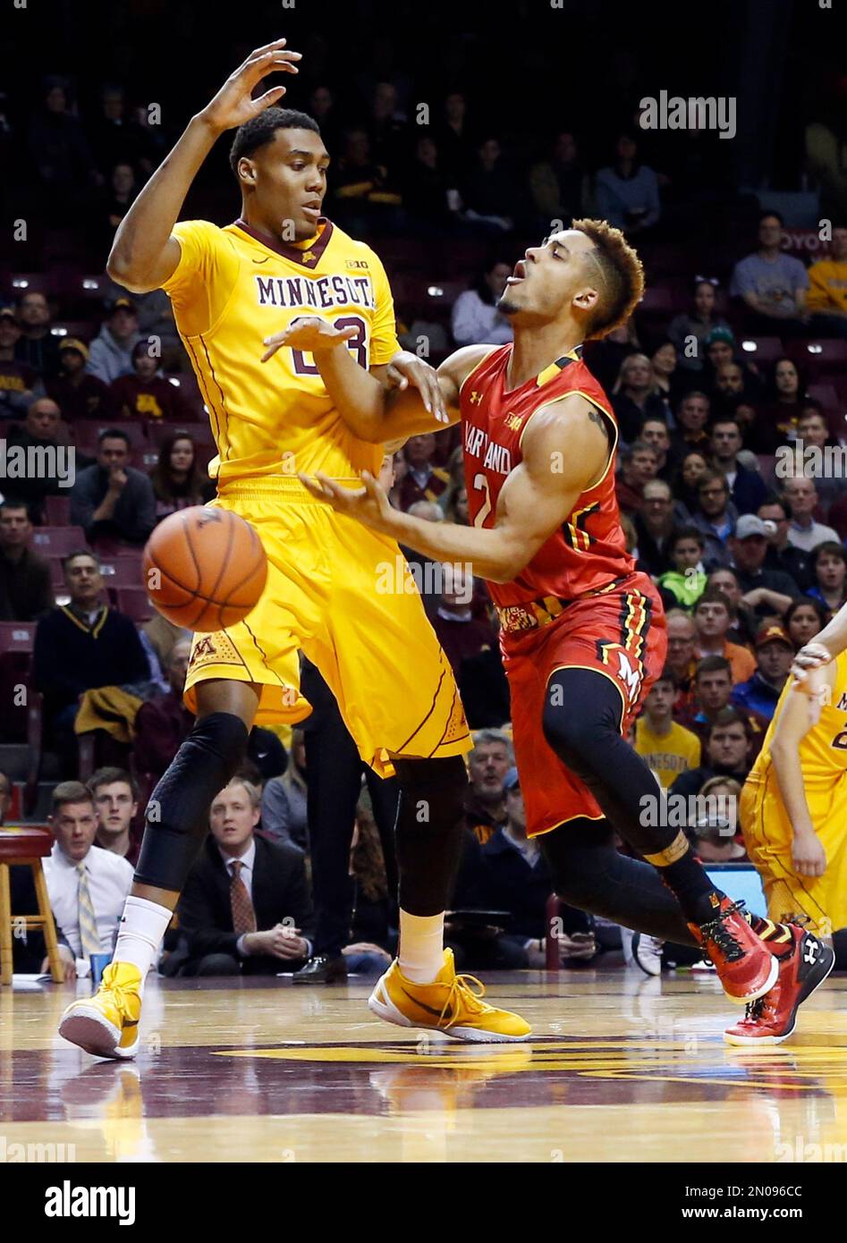 Maryland's Melo Trimble, right, gets tied up with Minnesota's Charles ...