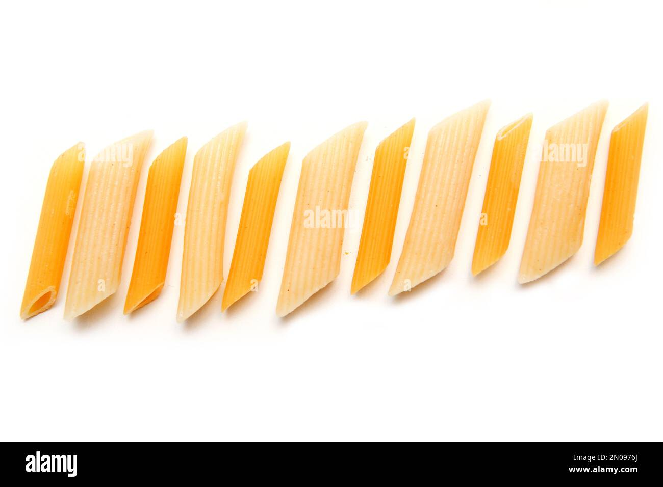 The comparison of the boiled and dry pasta. Different size and colors ...