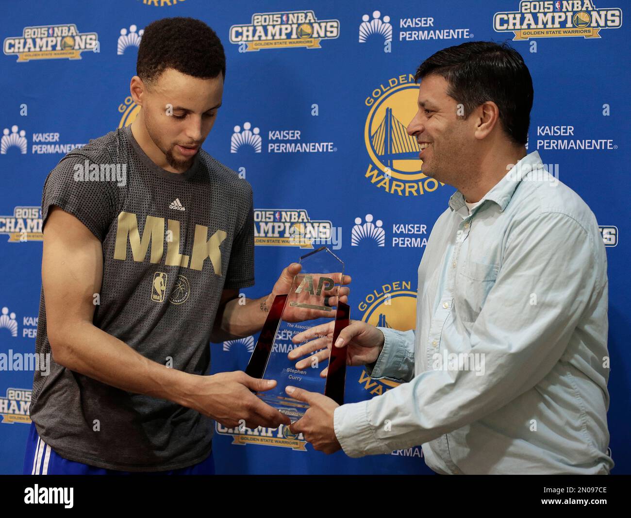 Golden State Warriors' Stephen Curry, left, accepts the AP Male Athlete ...