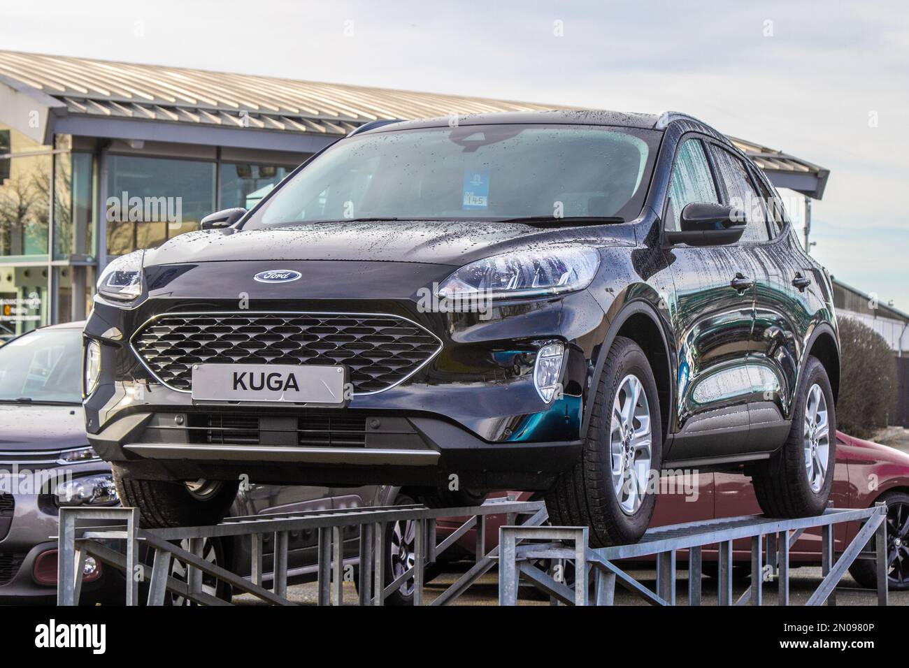 Black FORD KUGA on the forecourt of Evans Halsaw Ford car dealership in ...
