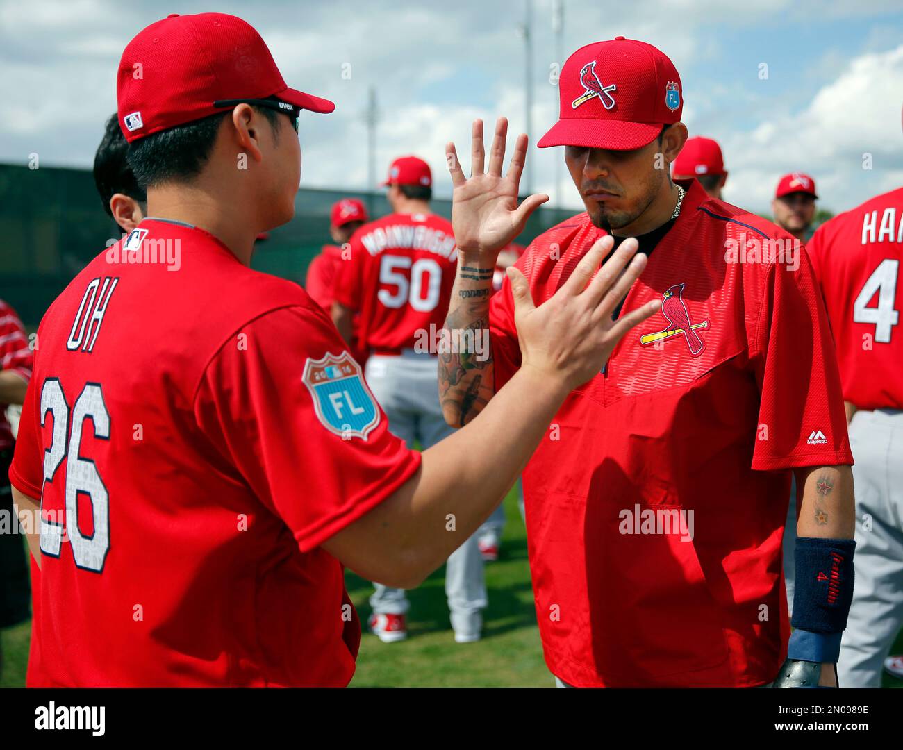 St. Louis Cardinals catcher Yadier Molina, right, gives a high-five to ...