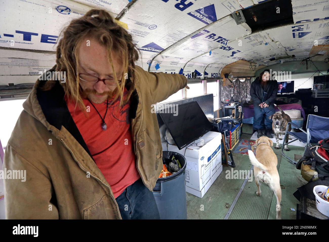 Danny Fletcher, left, calls to his dogs as Joshua Madrid looks on in an ...