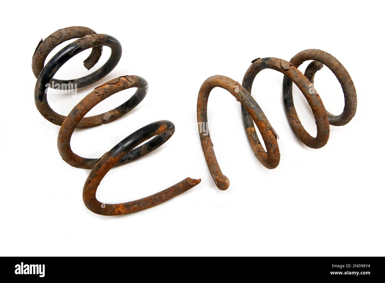 The old rusty broken coiled spring from the car suspension isolated in a white background Stock ...