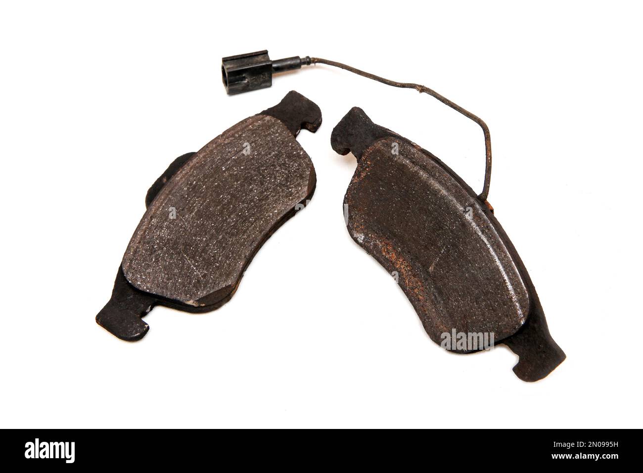The old used and rusty disc brake pads isolated in a white background ...