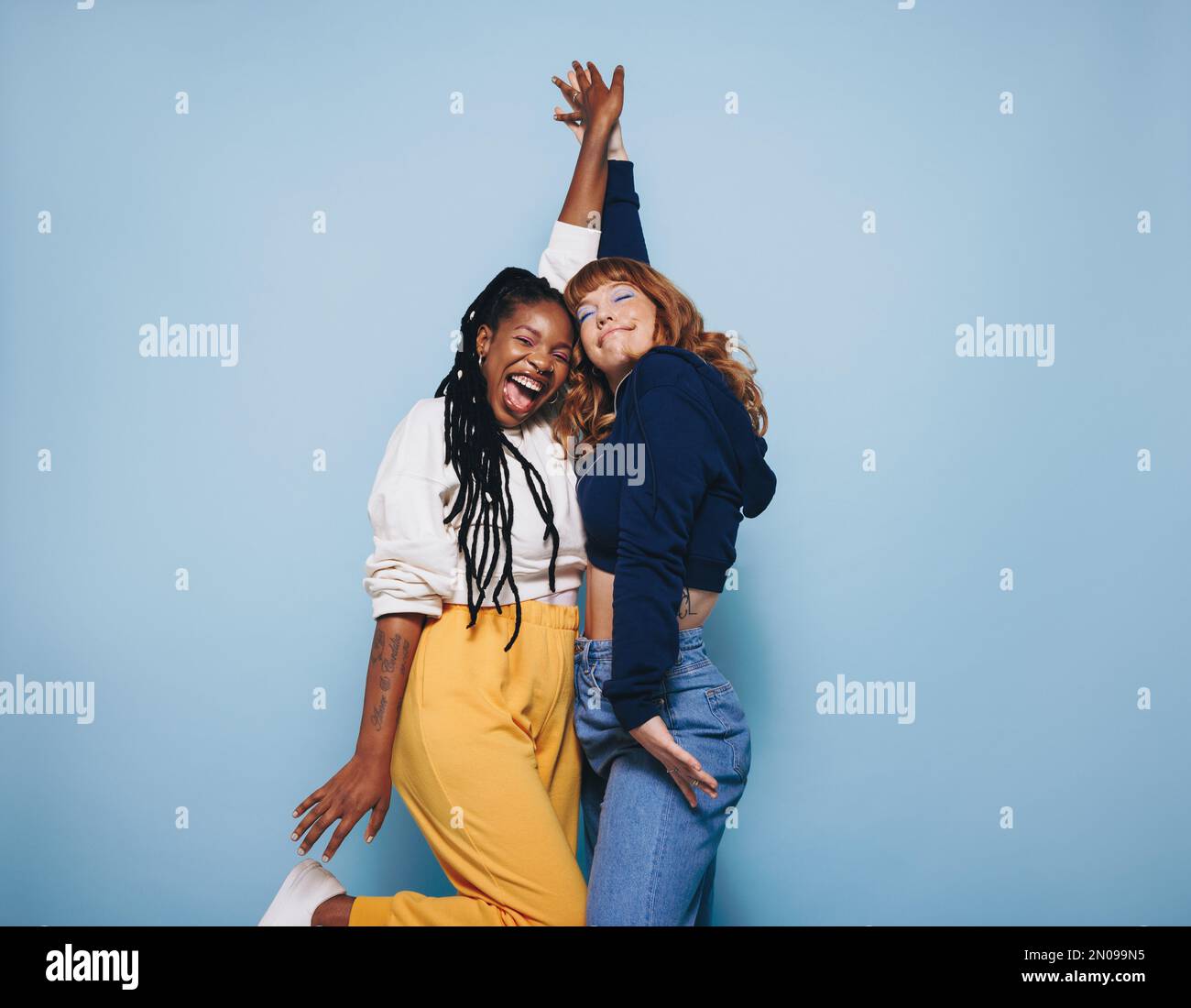 Two best friends dancing and having a good time together in a studio ...