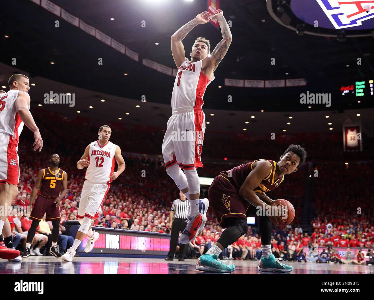 Arizona State guard Tra Holder (0) is defended by Arizona guard Gabe ...