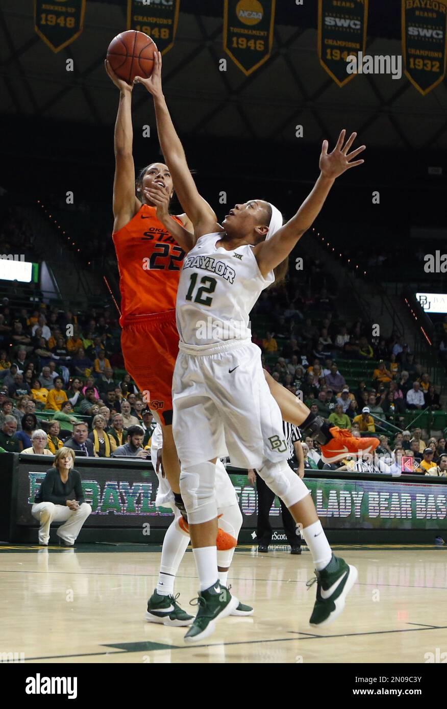 Oklahoma State guard Brittney Martin, left, attempts a shot over Baylor ...