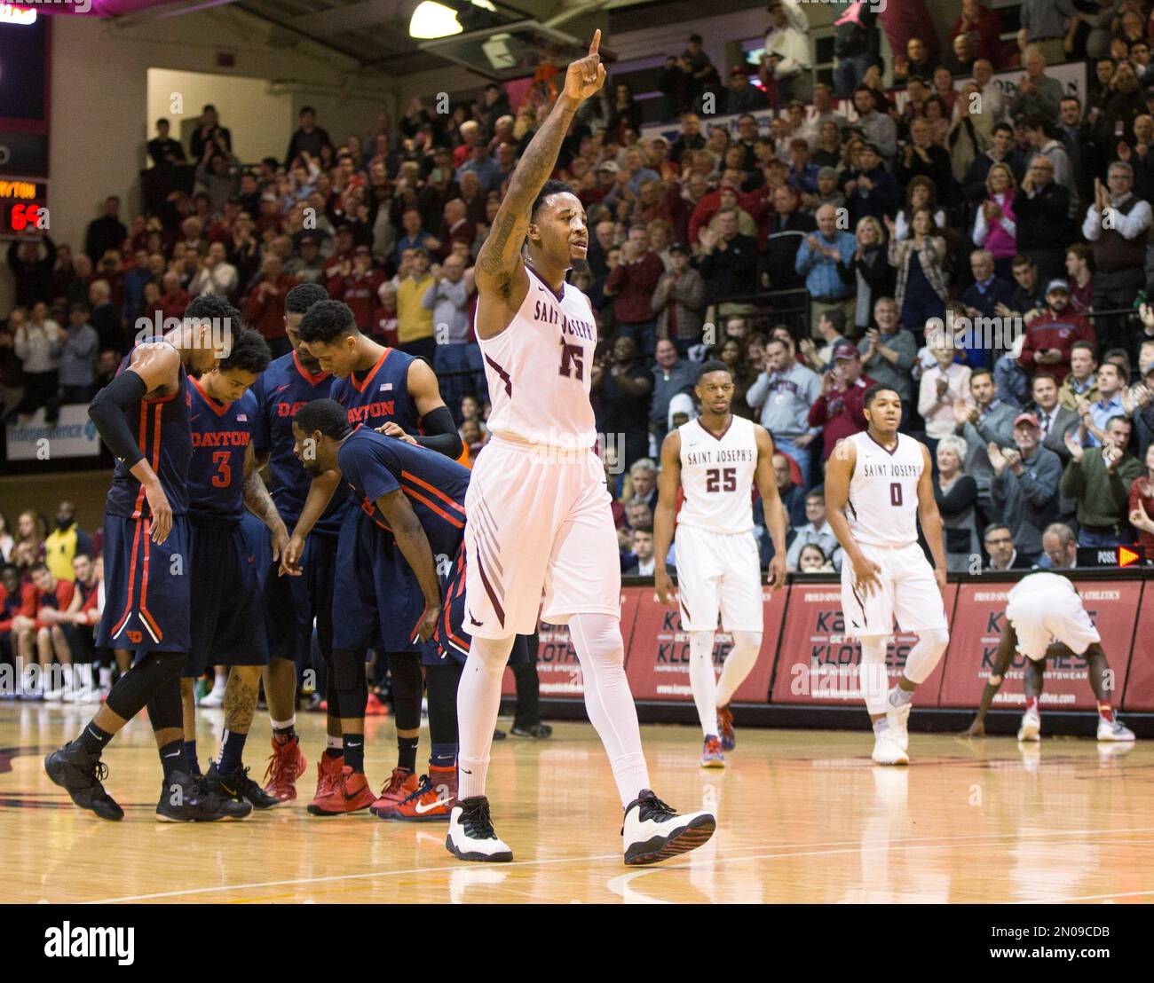 Saint Joseph's Isaiah Miles (15) reacts to his basket as Dayton players ...