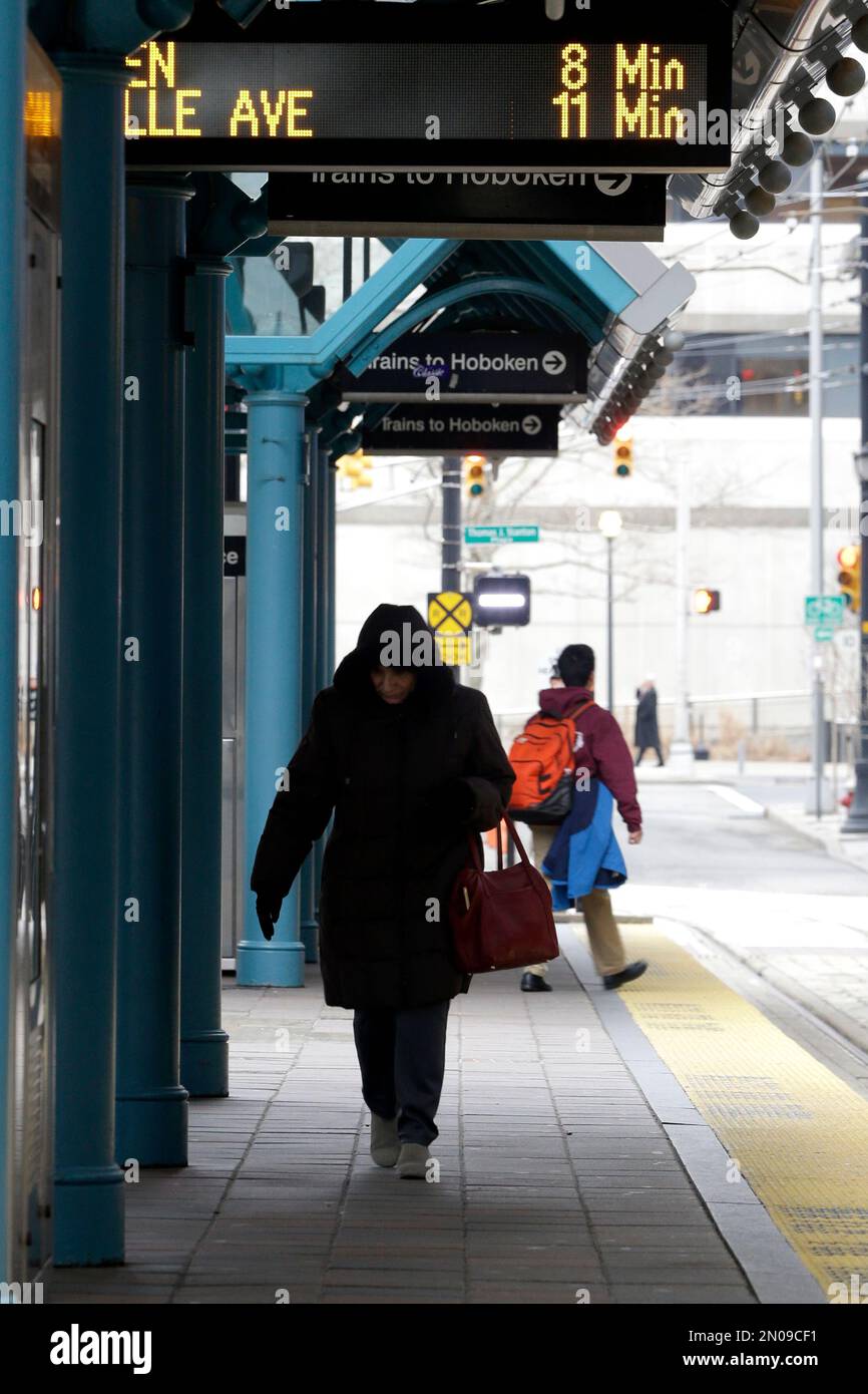 A commuter walks at the Exchange Place stop on the Hudson-Bergen Light ...