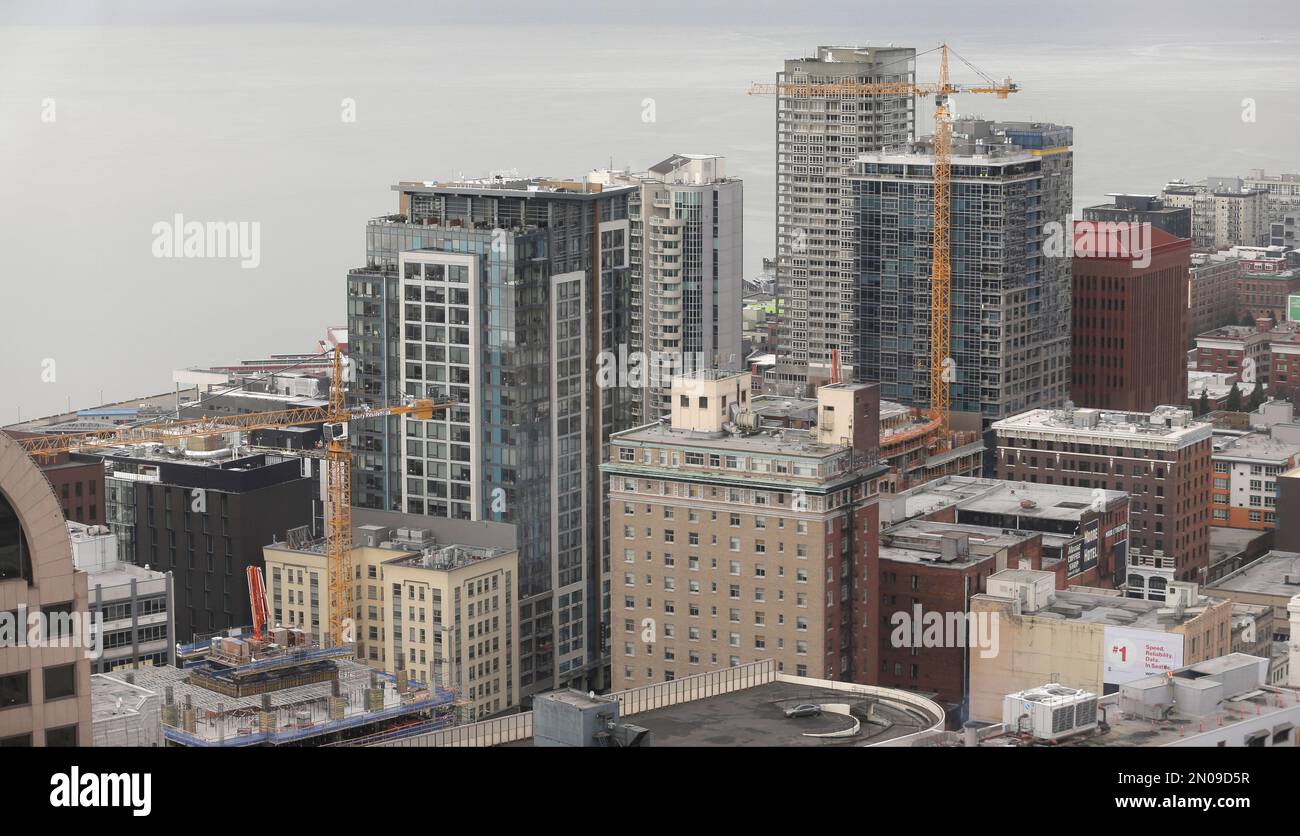Construction cranes are shown in downtown Seattle, Wednesday, Feb. 17 ...