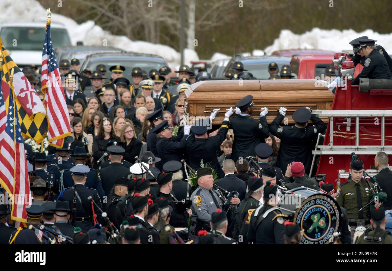 Members of the Joppa-Magnolia Volunteer Fire Company lift the casket of ...