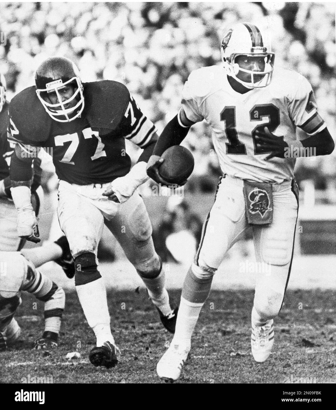 Quarterback Doug Williams (12) of the Tampa Bay Buccaneers is pursued ...