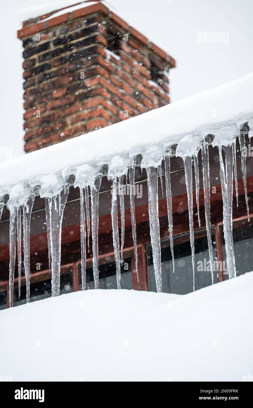 Dangerous sharp icicles and snow hanging from the roof. Dangerous ...