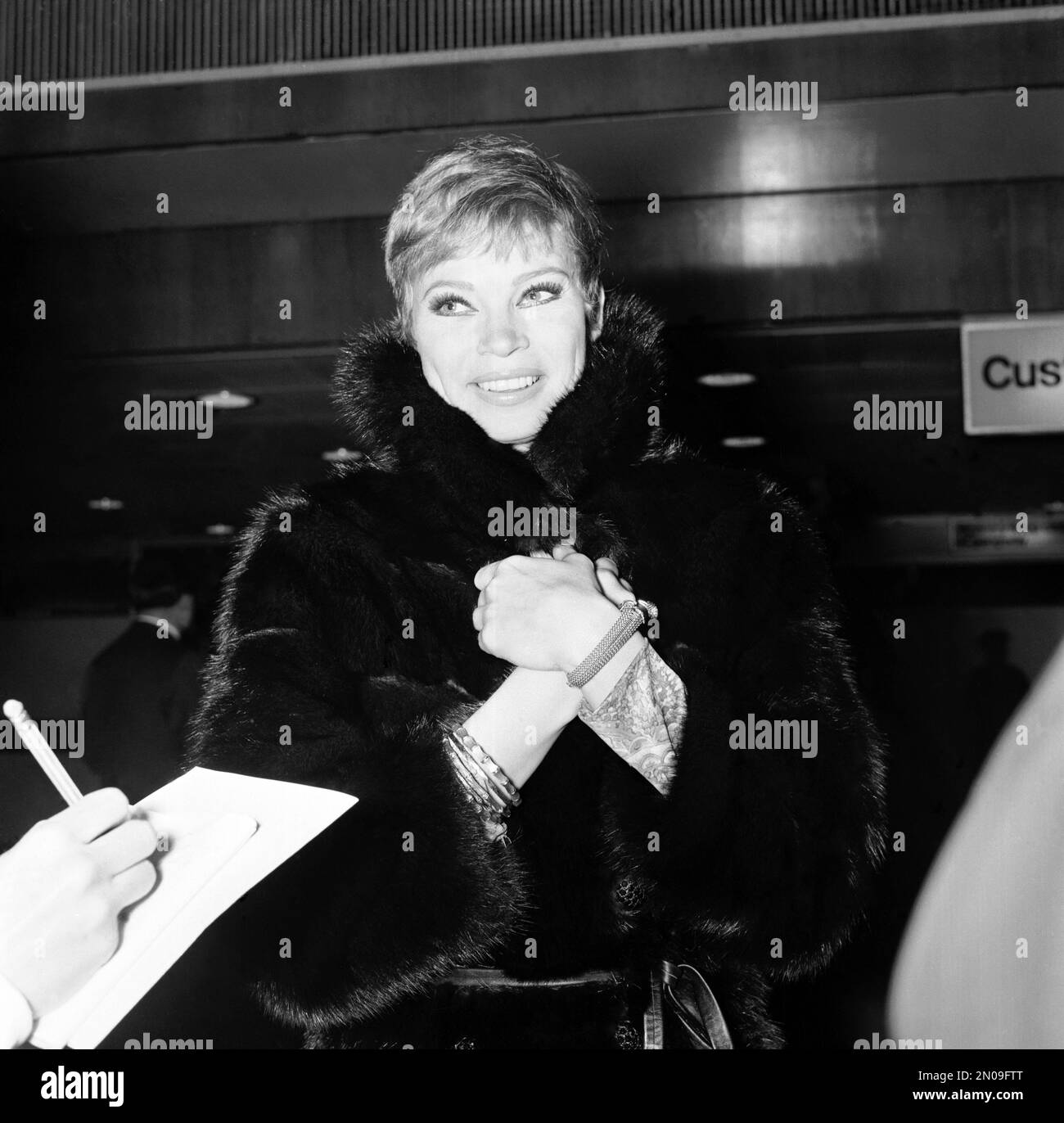 Clad in a black fur coat, actress Juliet Prowse arrives at London's ...