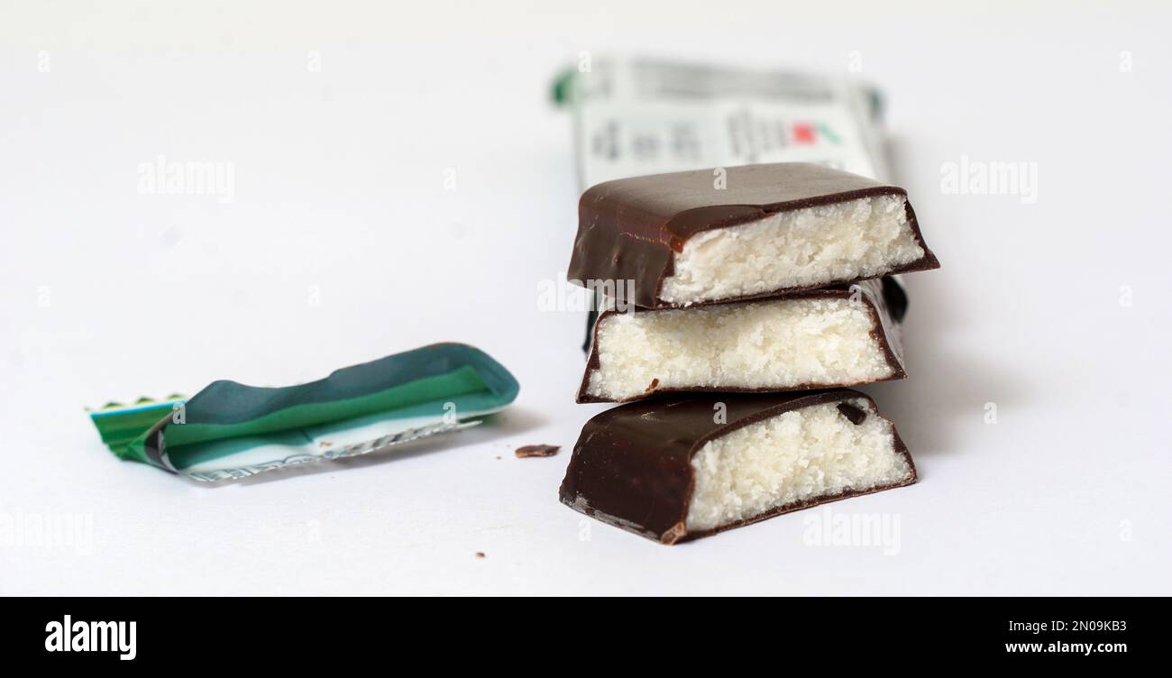 Chocolate Protein bar filled with chocolate sauce, cut on a white ...