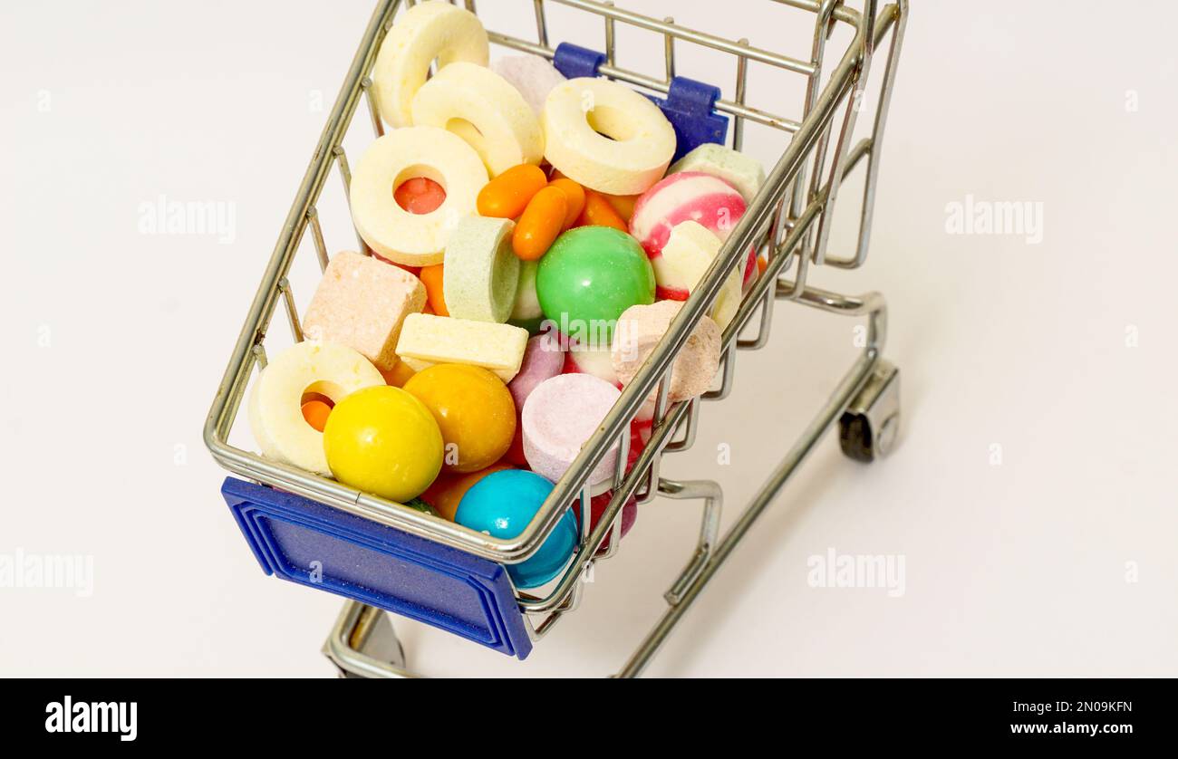 lot of colorful various flavor candies in a small shopping cart Stock ...