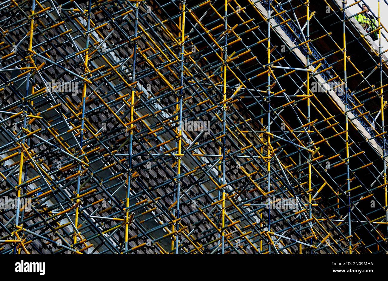 A worker stands on the scaffolding clutter at the new Tate Modern ...