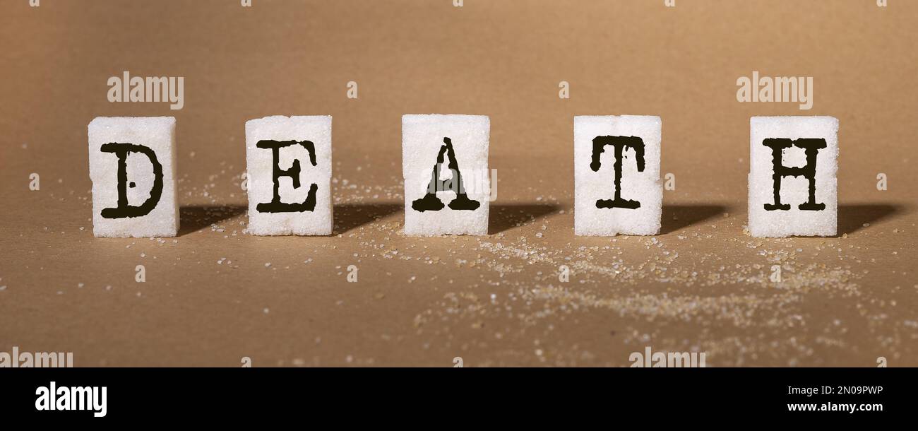 Death word on refines white sugar cubes, pieces. Excessive consumption ...