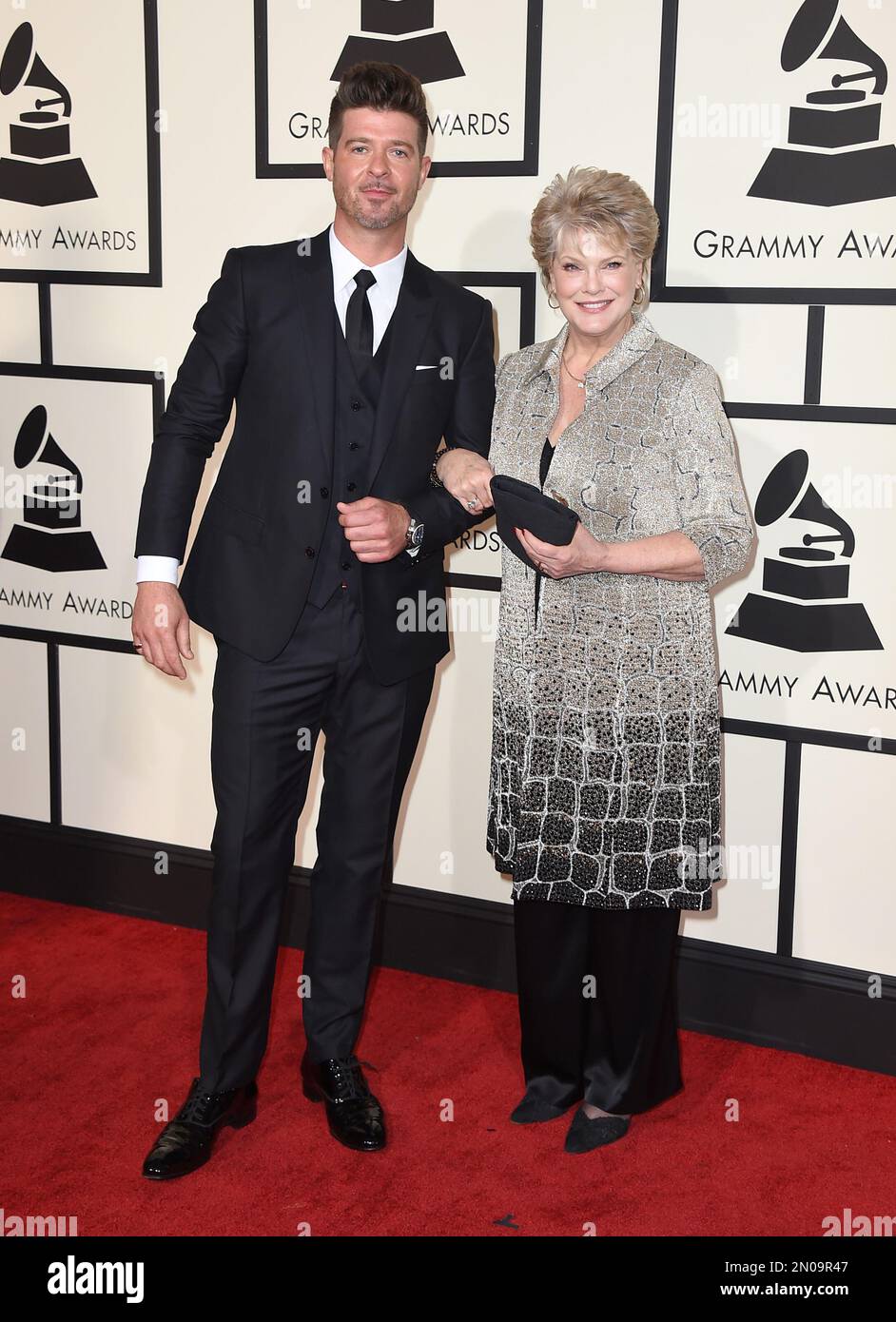 Robin Thicke, left, and Gloria Loring arrive at the 58th annual Grammy ...