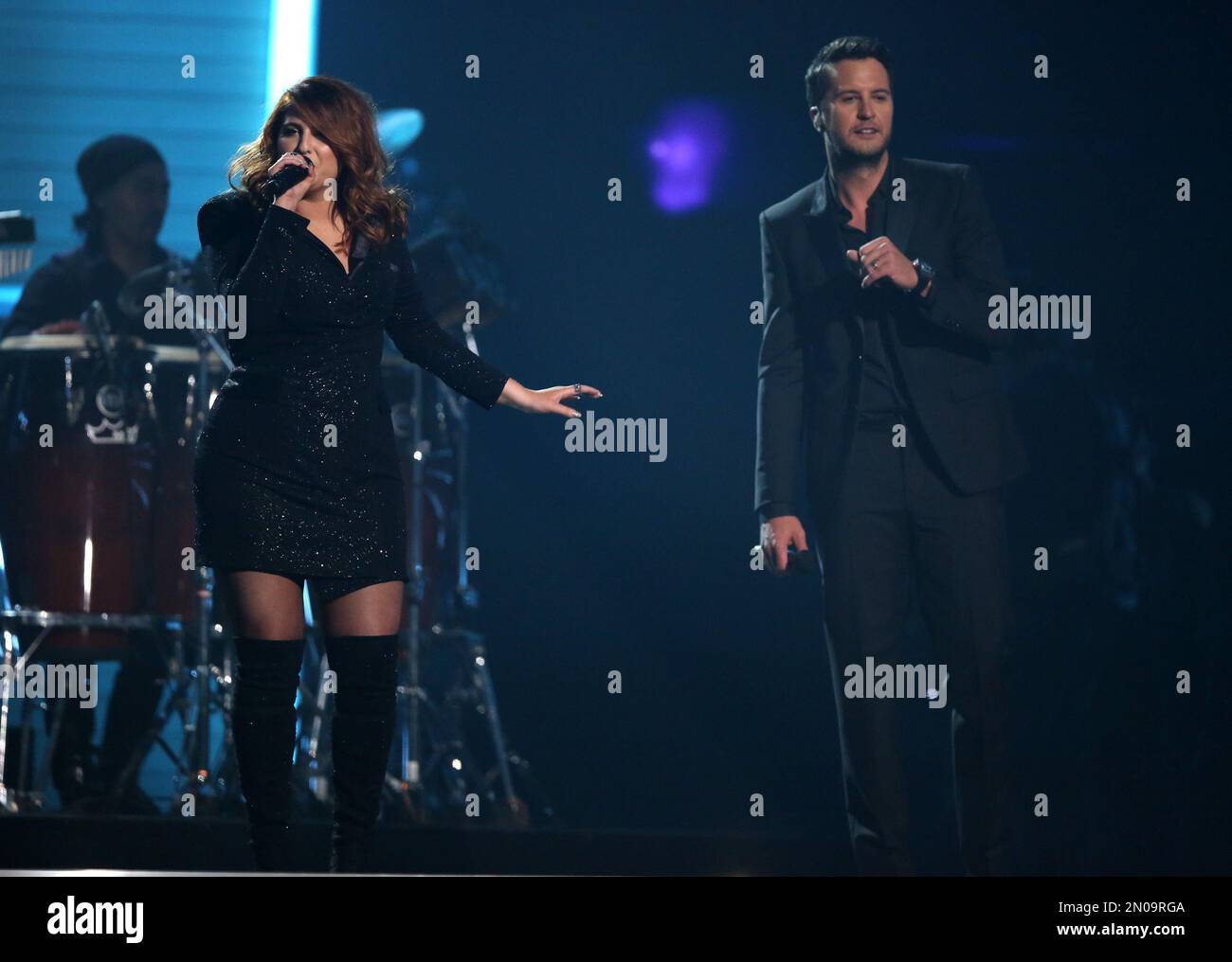 Meghan Trainor, left, and Luke Bryan perform a tribute to MusiCares ...