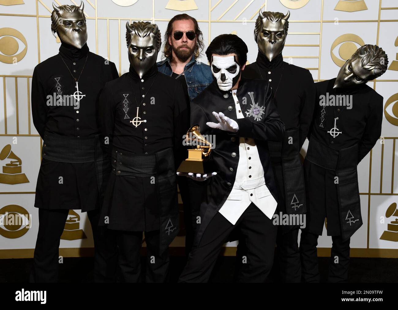 Ghost poses in the press room with the award for best metal performance ...