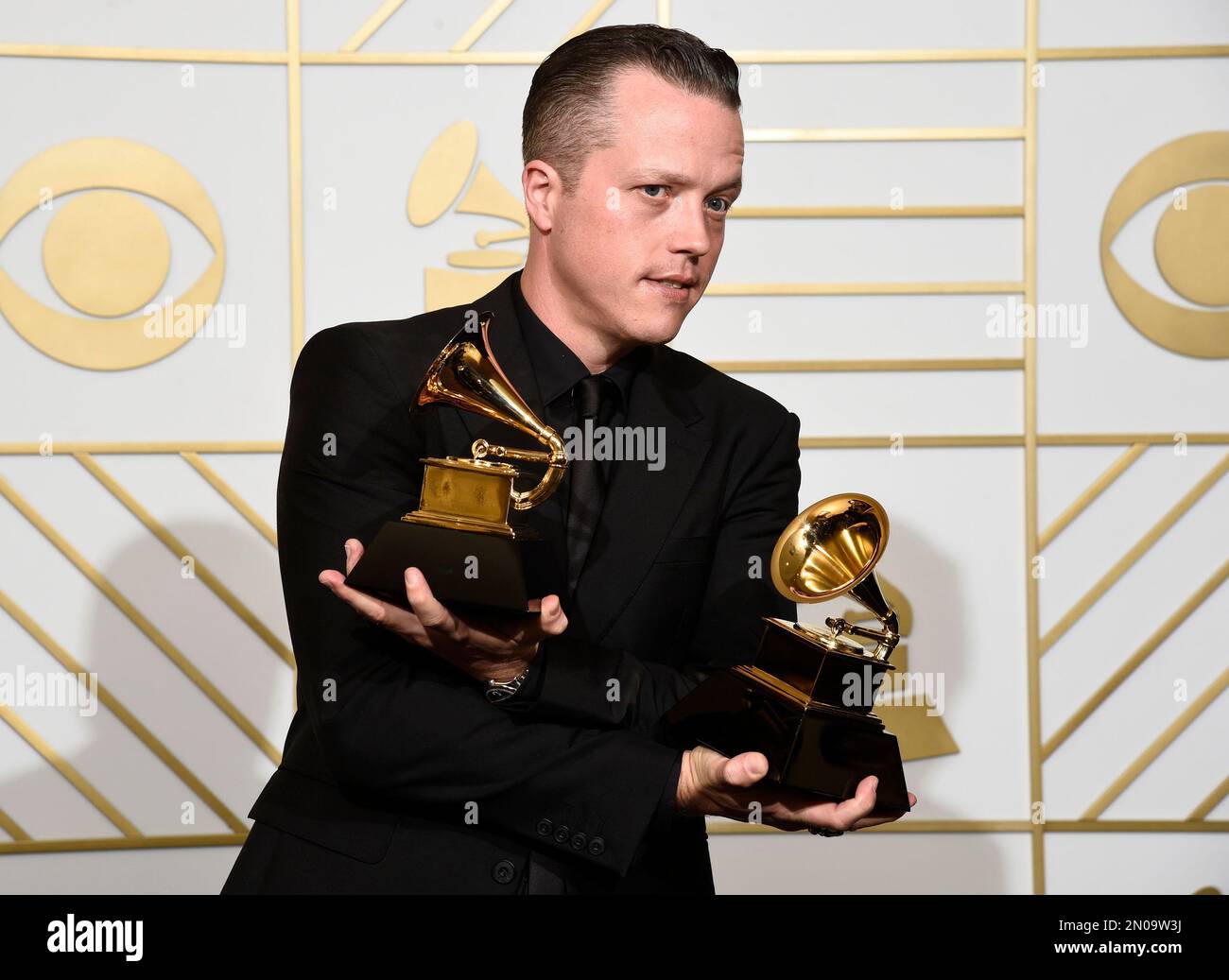 Jason Isbell poses in the press room with the awards for best americana ...