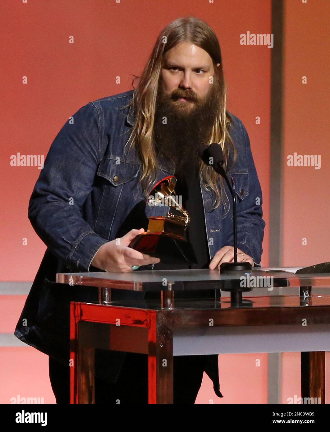 Chris Stapleton accepts the award for best country solo performance for ...