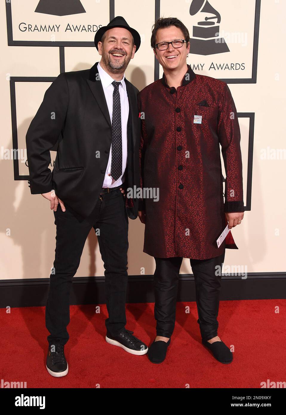 Dave Stringer, left, and Madi Das arrive at the 58th annual Grammy ...