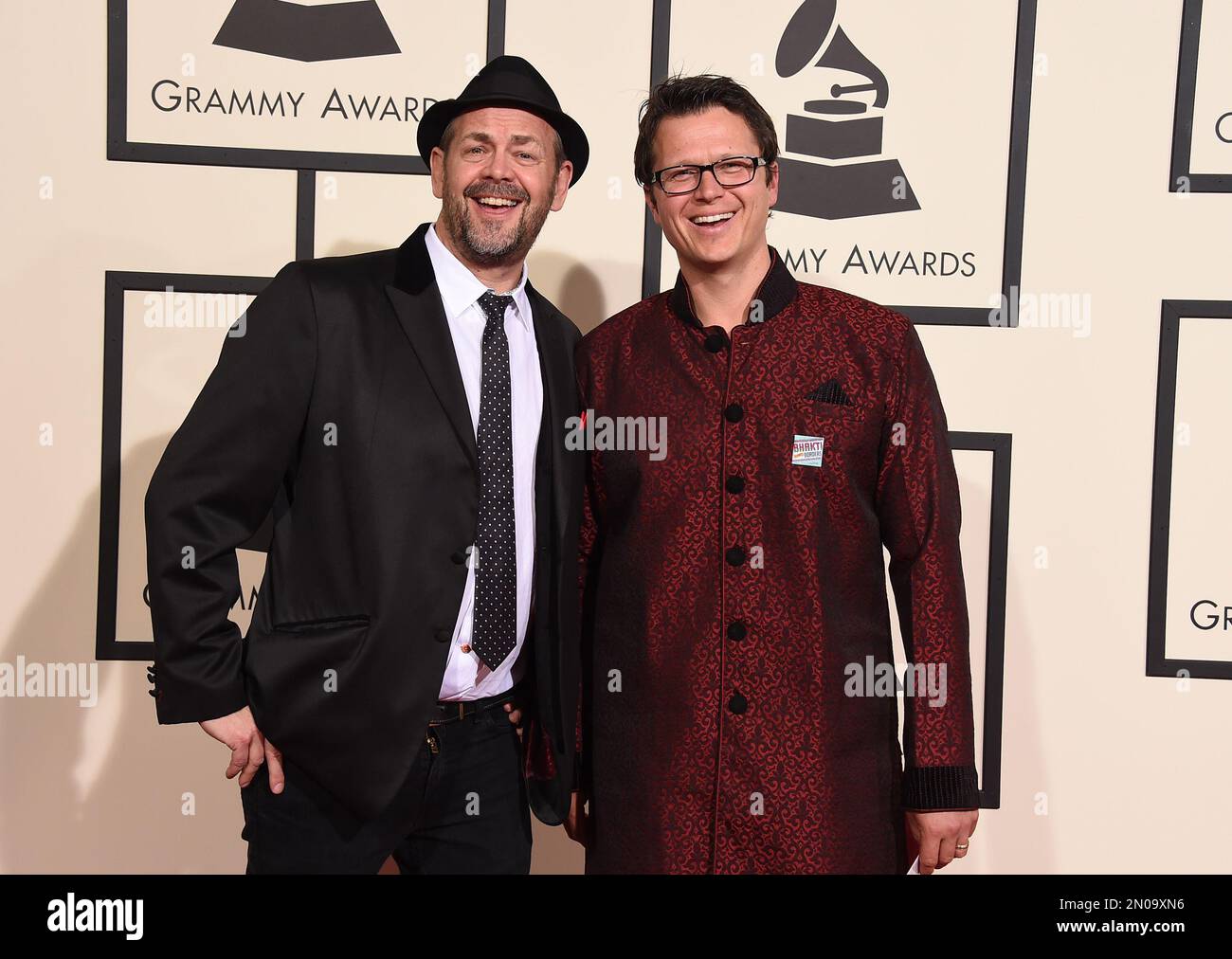 Dave Stringer, left, and Madi Das arrive at the 58th annual Grammy ...