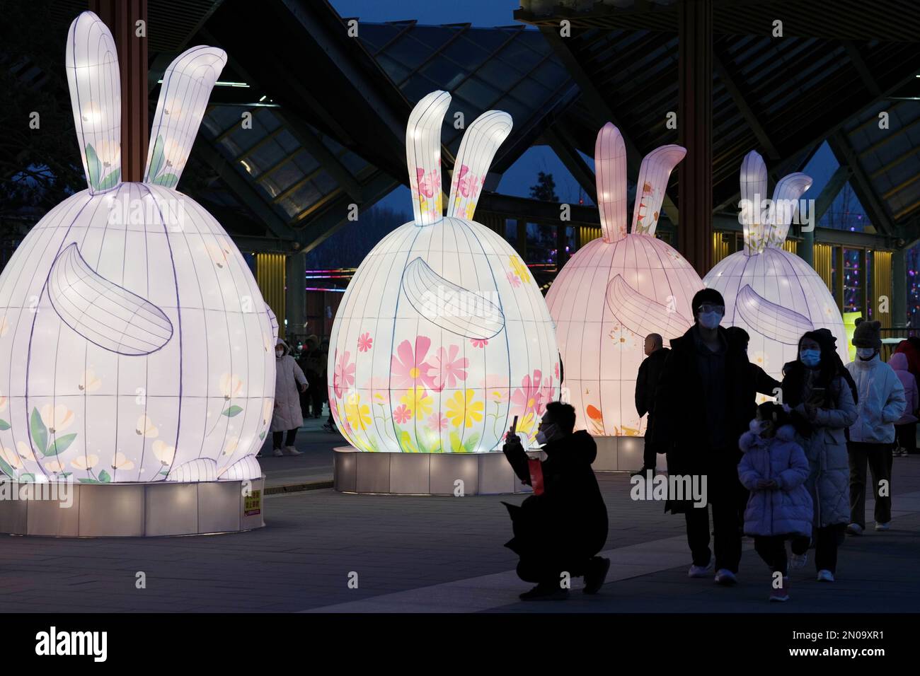Beijing, China. 5th Feb, 2023. Tourists look at light installations ...