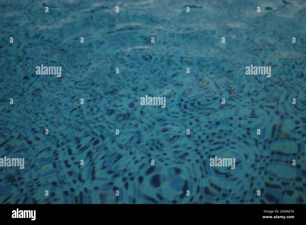 Mosaic swimming pool with rippling water Stock Photo - Alamy