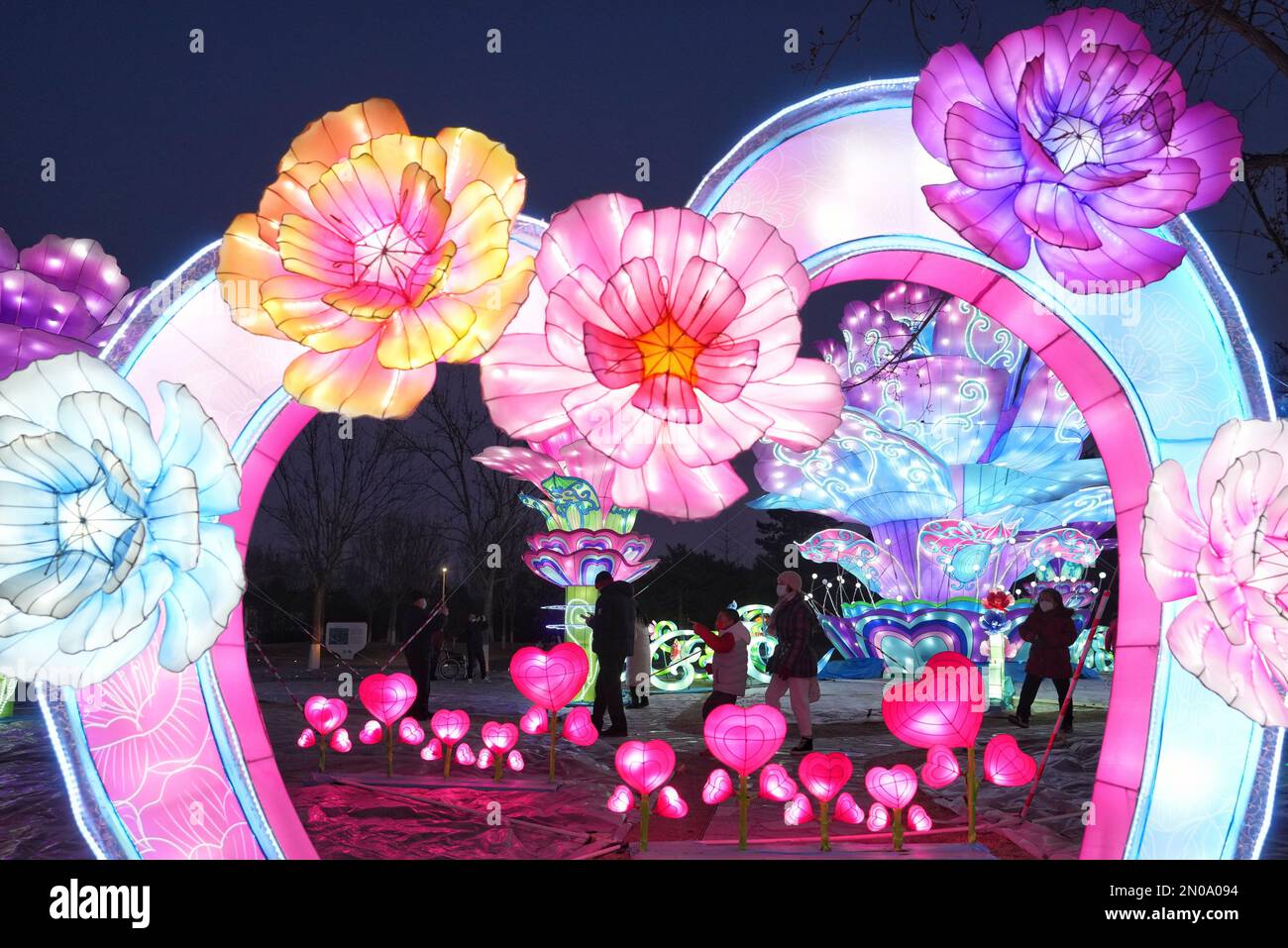 Beijing, China. 5th Feb, 2023. Tourists look at light installations ...