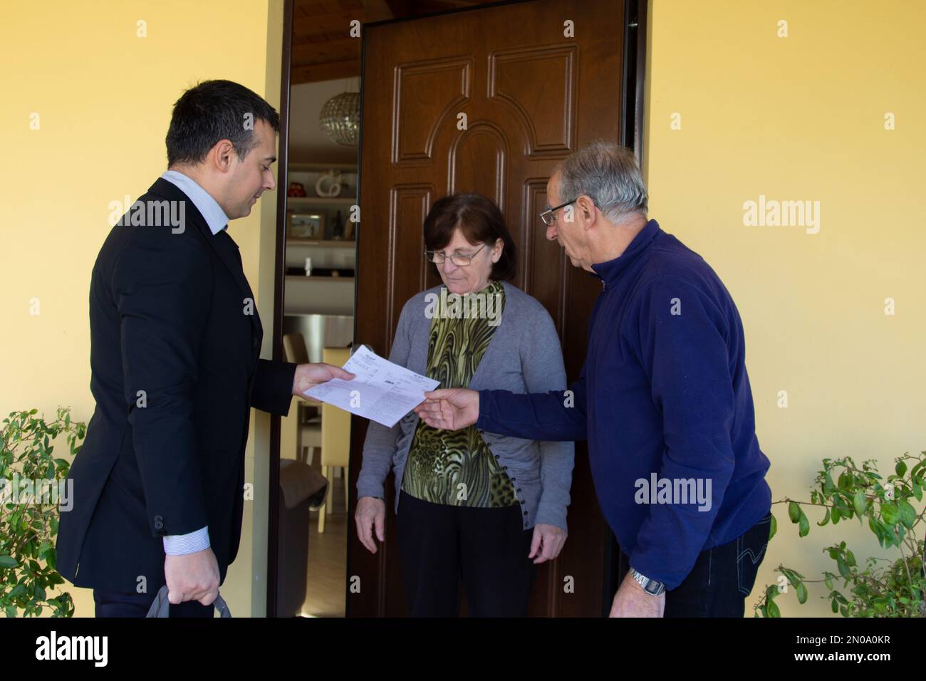 Elegant smiling man knocking door to door to explain the electoral ...