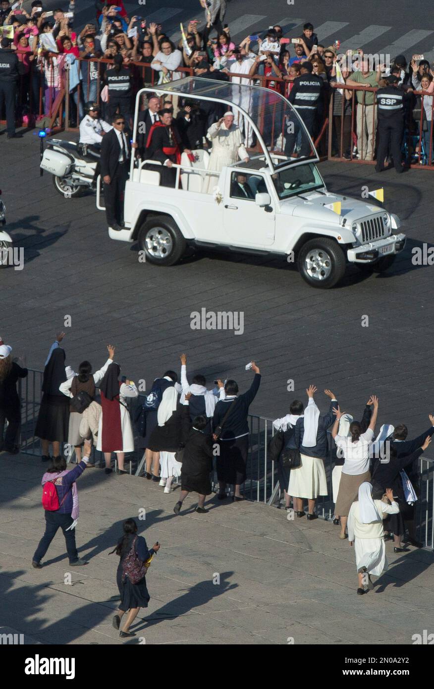 A superfluity of nuns wave to Pope Francis from the base of the Angel ...