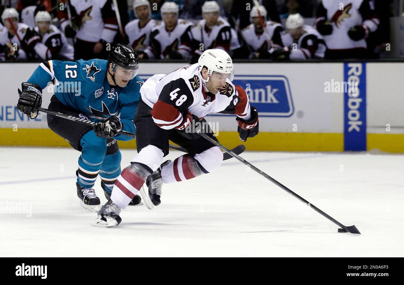Arizona Coyotes' Jordan Martinook (48) is chased by San Jose Sharks ...