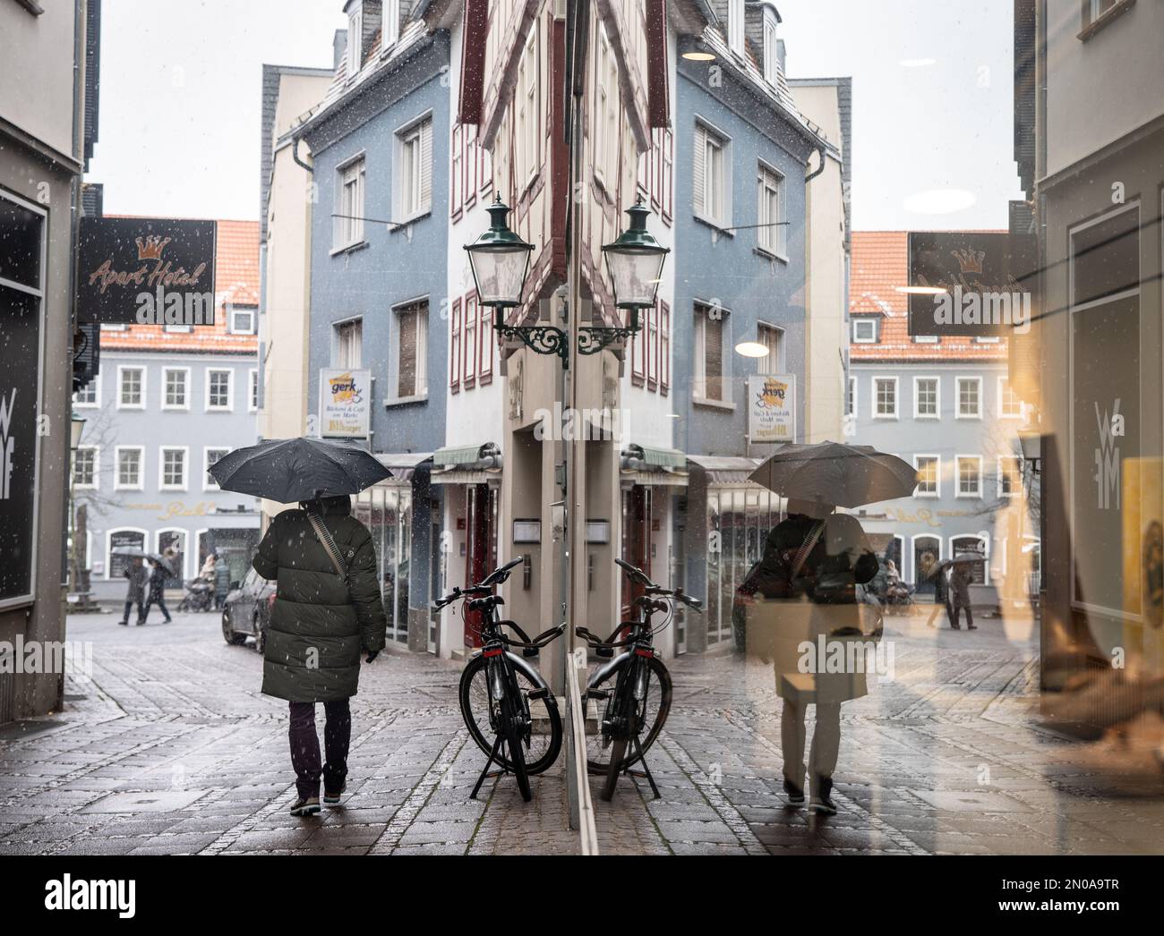 05 February 2023, Hesse, Fulda: A woman walks through an alley on the ...