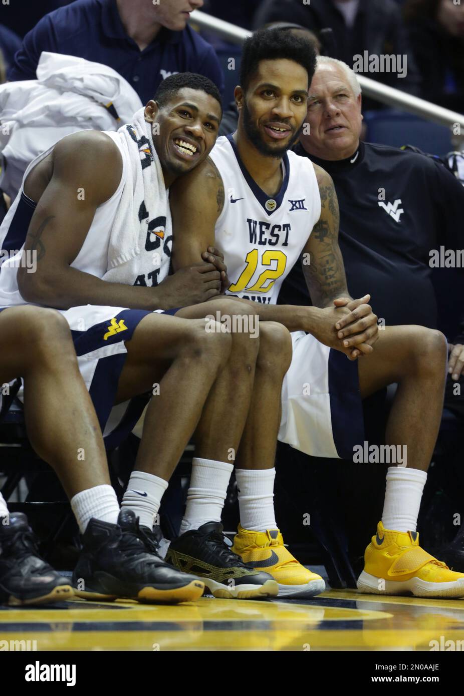 West Virginia forward Jonathan Holton (1) and West Virginia guard Tarik ...