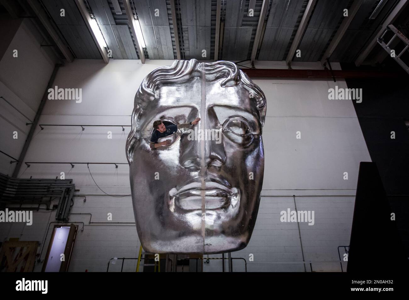 Set builder Charlie Wright works on a giant replica of the British ...