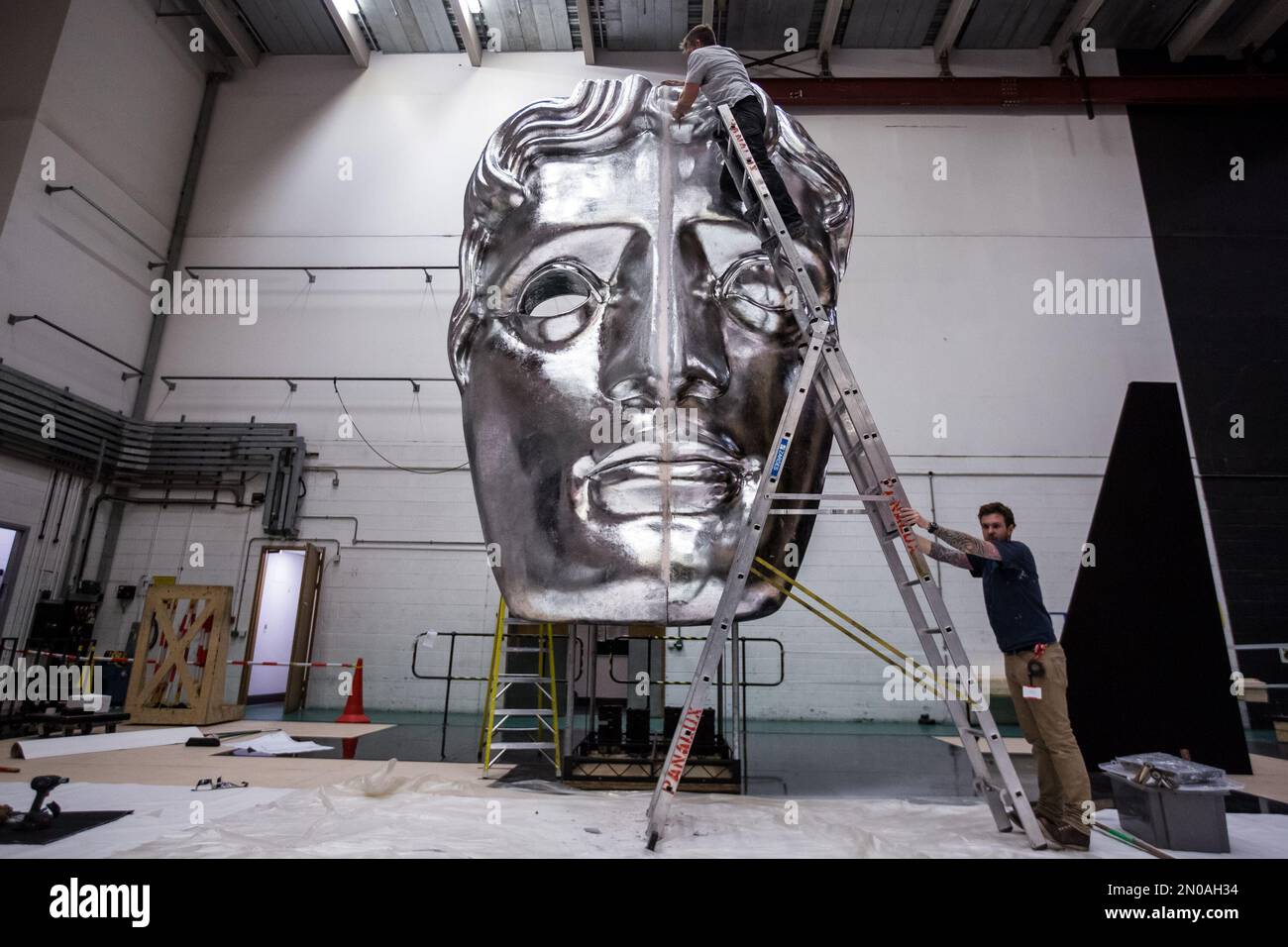 Set builders work on a giant replica of the British Academy Films ...