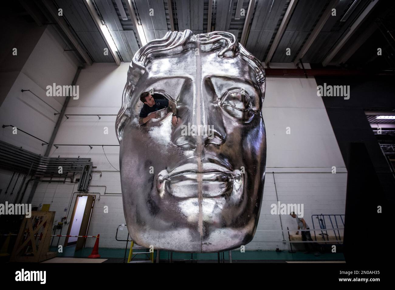 Set builder Charlie Wright works on a giant replica of the British ...