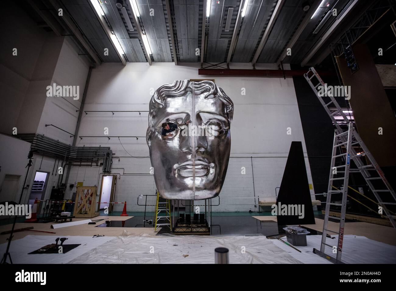 Set builder Charlie Wright works on a giant replica of the British ...