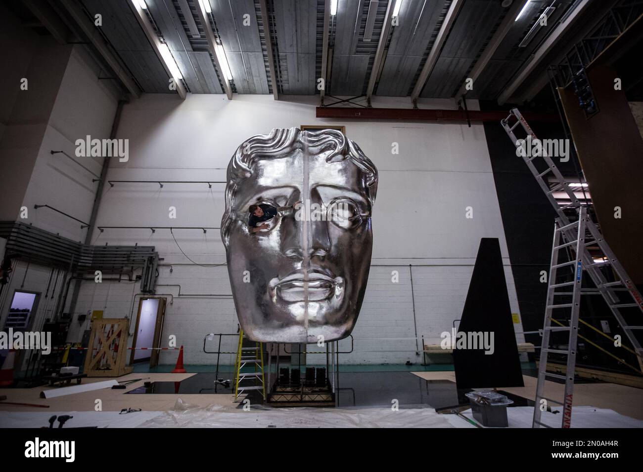 Set builder Charlie Wright works on a giant replica of the British ...