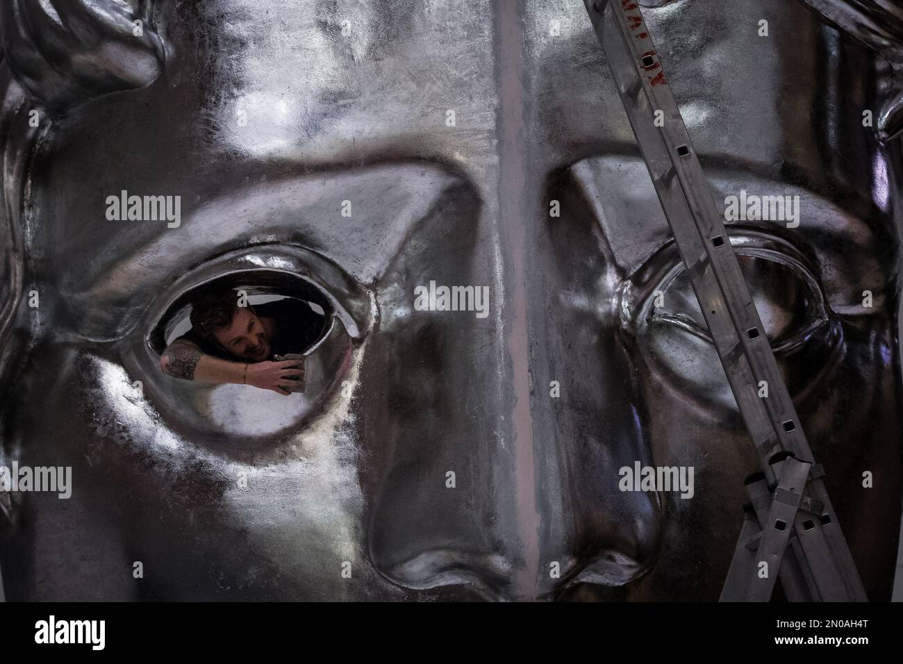 Set builder Charlie Wright works on a giant replica of the British ...